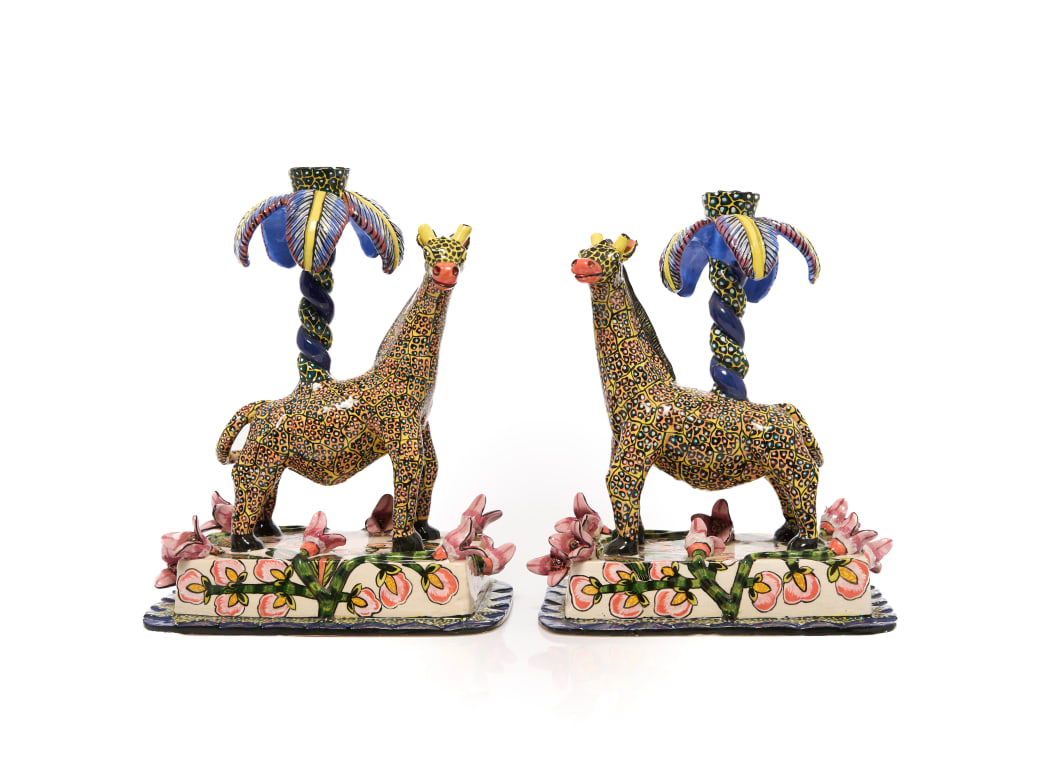 Pair of candle sticks with giraffe, palm tree and flower motifs, two by ...