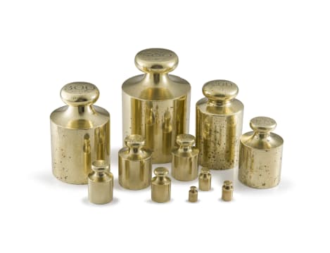 Eleven brass troy ounce weights | Strauss & Co