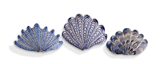 Curated collection of three glazed ceramic shells with blue motifs by ...