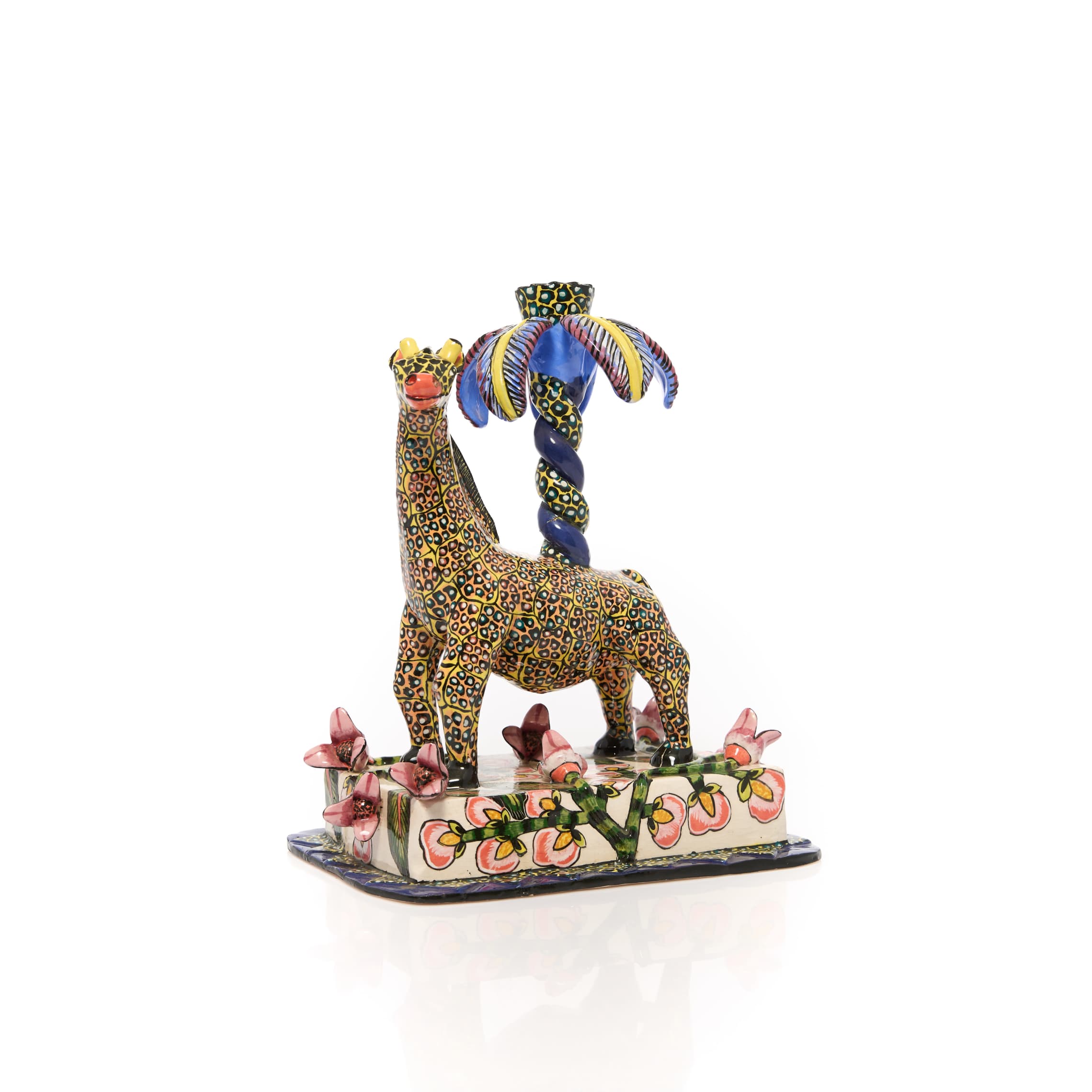 Pair of candle sticks with giraffe, palm tree and flower motifs, two by ...